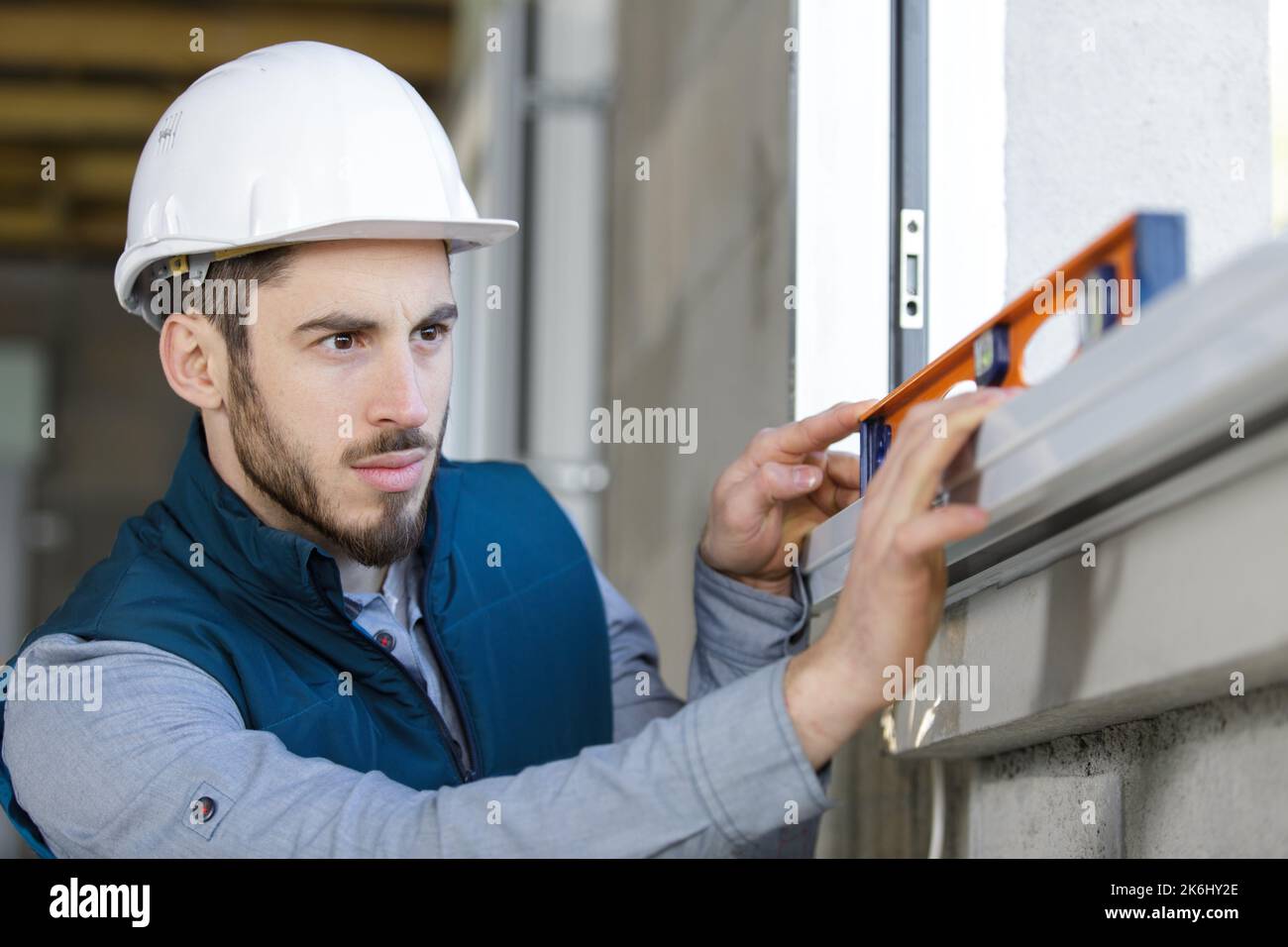 workman using special tool and checking level of window-frame Stock ...