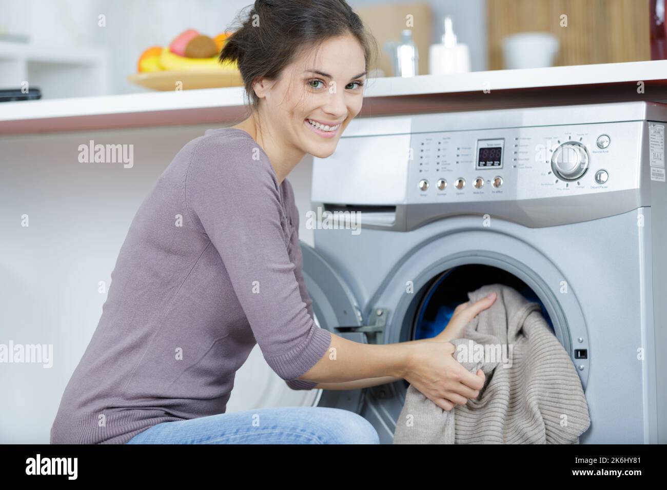 Woman using washing machine hi-res stock photography and images - Alamy