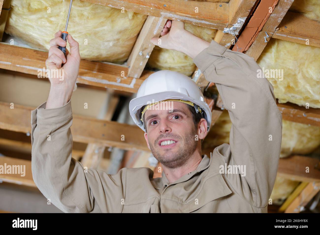 male builder working on ceiling joist Stock Photo - Alamy