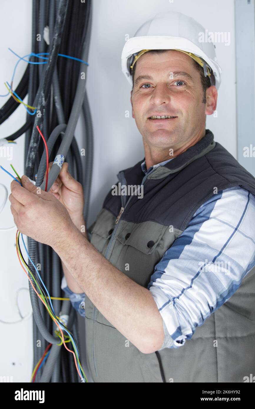 electrical worker wiring in modern building Stock Photo - Alamy