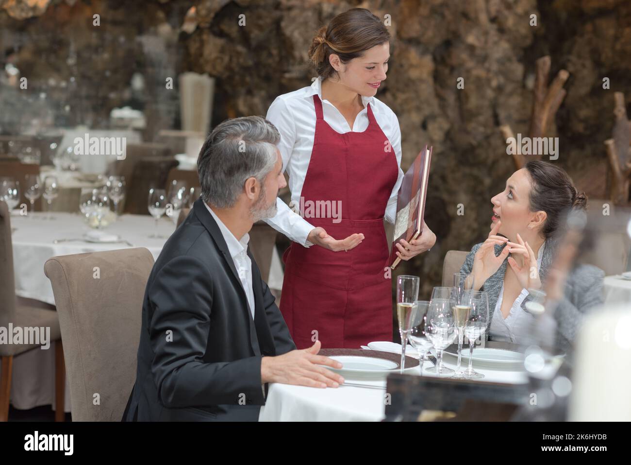 female waitress with couple in restaurant Stock Photo - Alamy