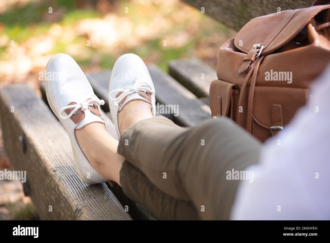 senior woman feet on park bench Stock Photo - Alamy