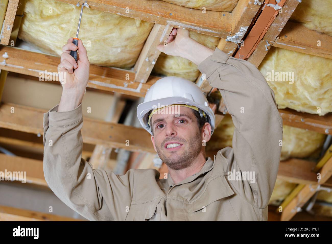 man working on wooden ceiling joists Stock Photo - Alamy