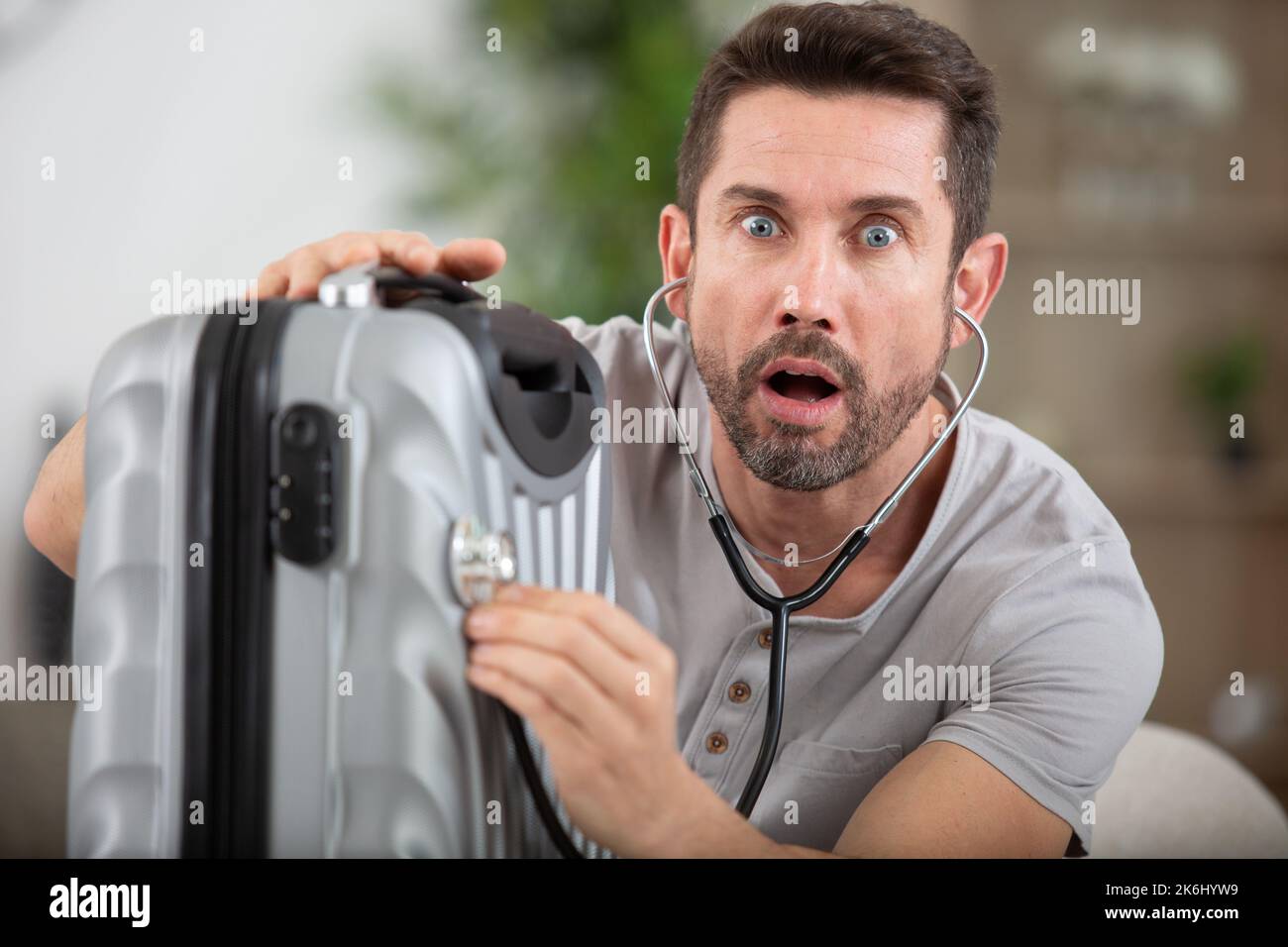 man using stethoscope on his suitcase Stock Photo - Alamy