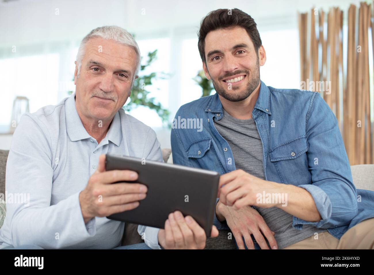 man howing an interesting article to his elderly father Stock Photo - Alamy
