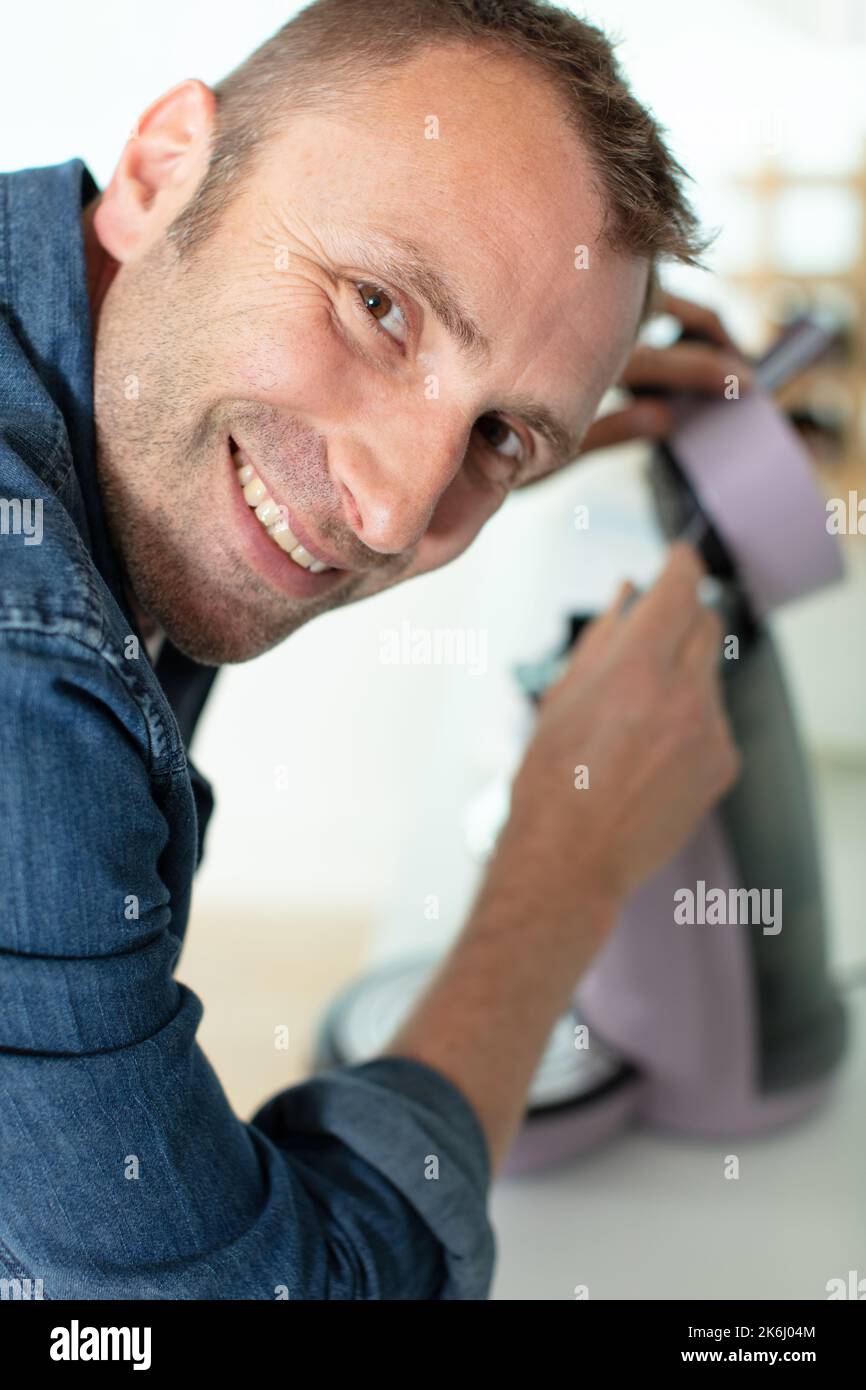 serious man repairing broken coffee machine Stock Photo - Alamy