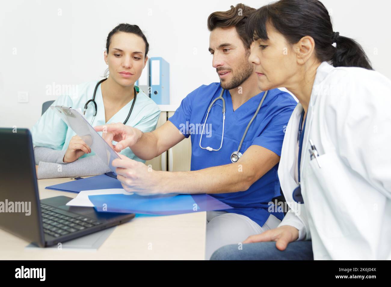 medical team meeting around table in modern hospital Stock Photo - Alamy