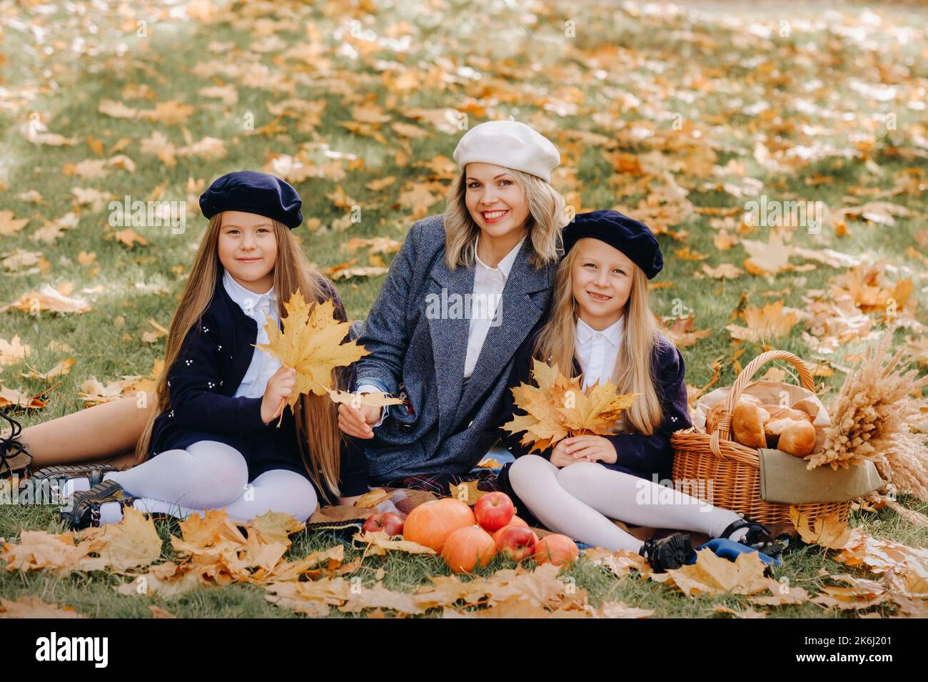 A big family on a picnic in the fall in a nature park. Happy people in ...