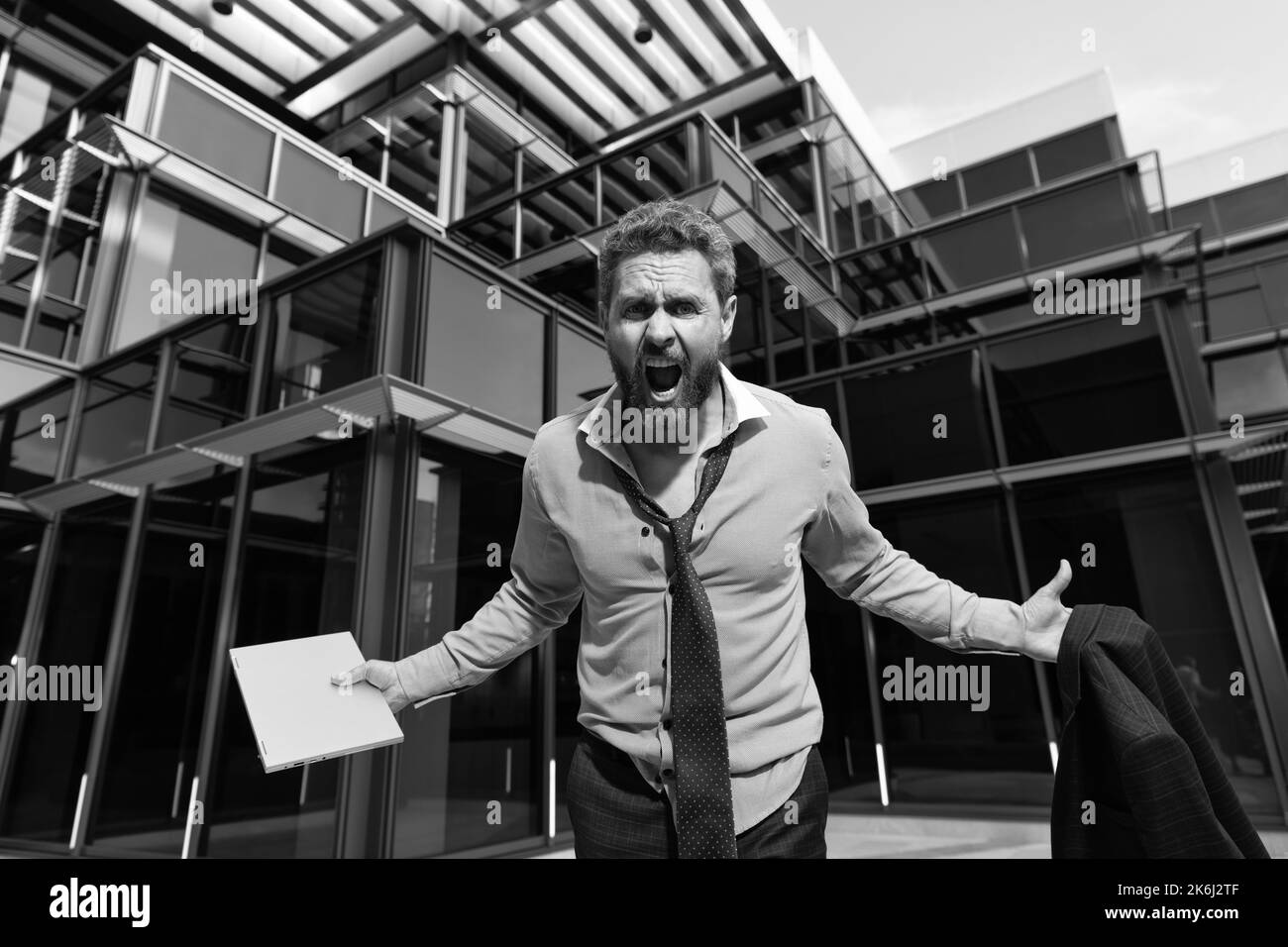depressed businessperson shouting outside office with computer, job ...