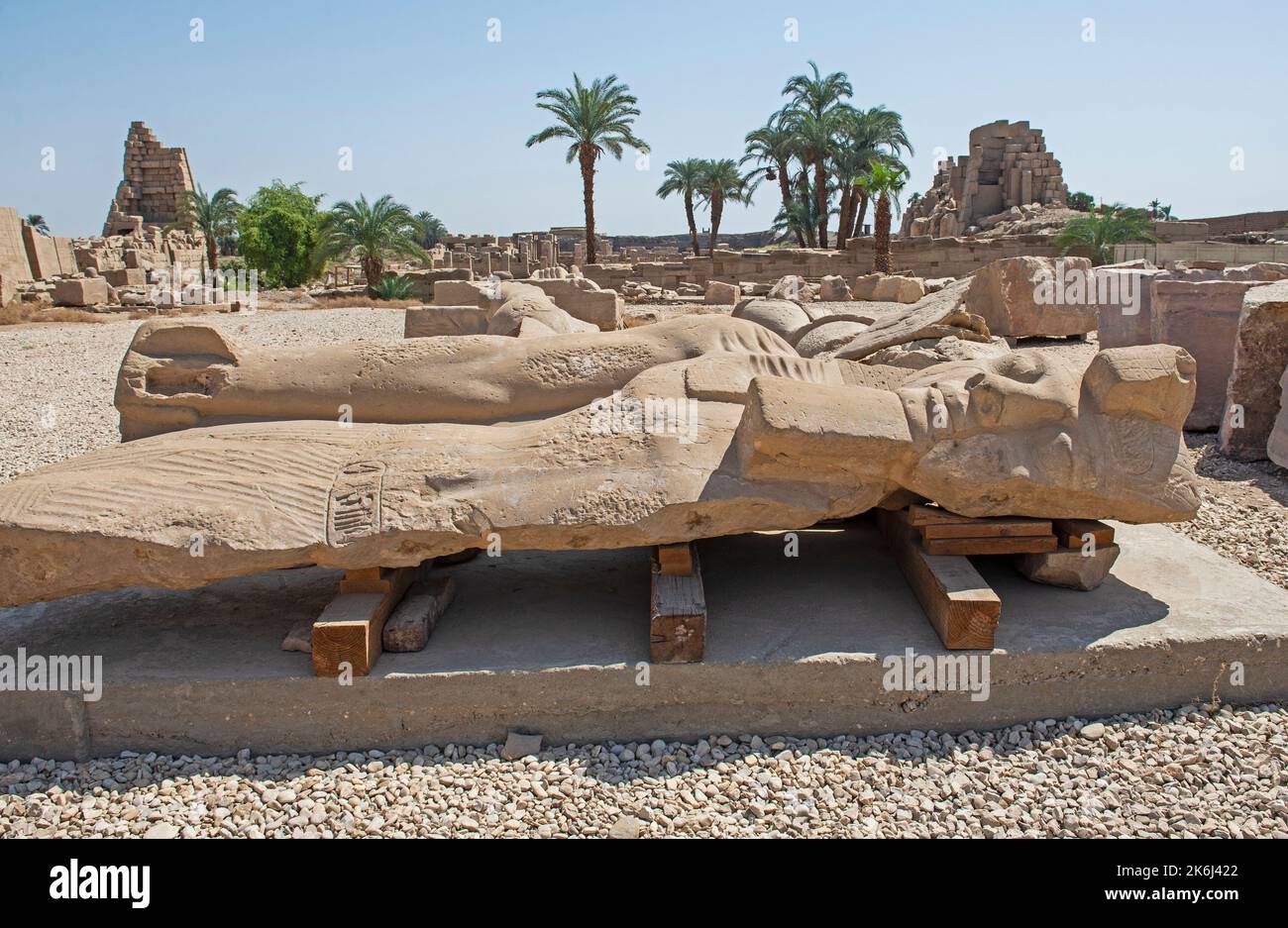 Large broken statue of Ramses II in ancient egyptian Karnak Temple ...