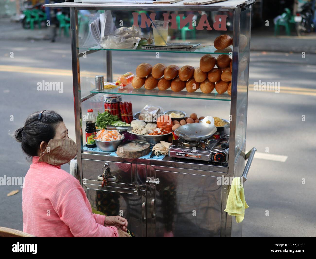 food stand with a women selling bread and ham, banh mi Stock Photo - Alamy