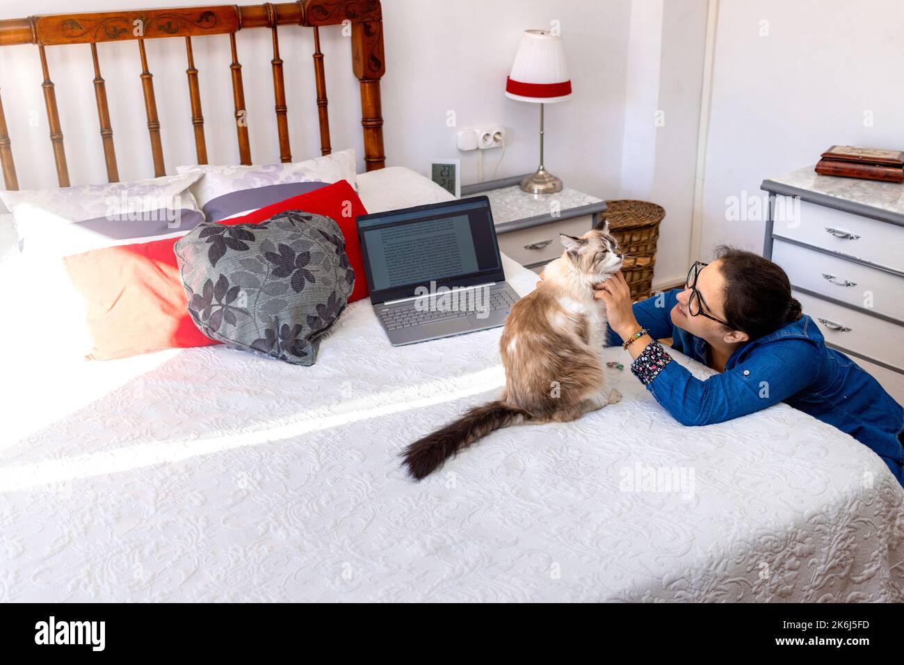 Woman Stroking her Cat. Work at Home interrupted by Pet. Love of Cats ...