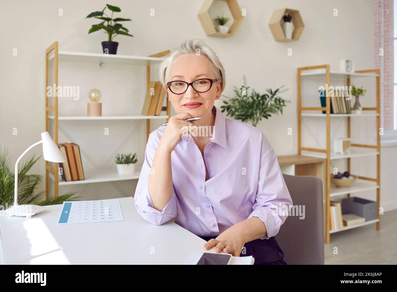 Portrait of elegant successful senior business woman team leader and ...