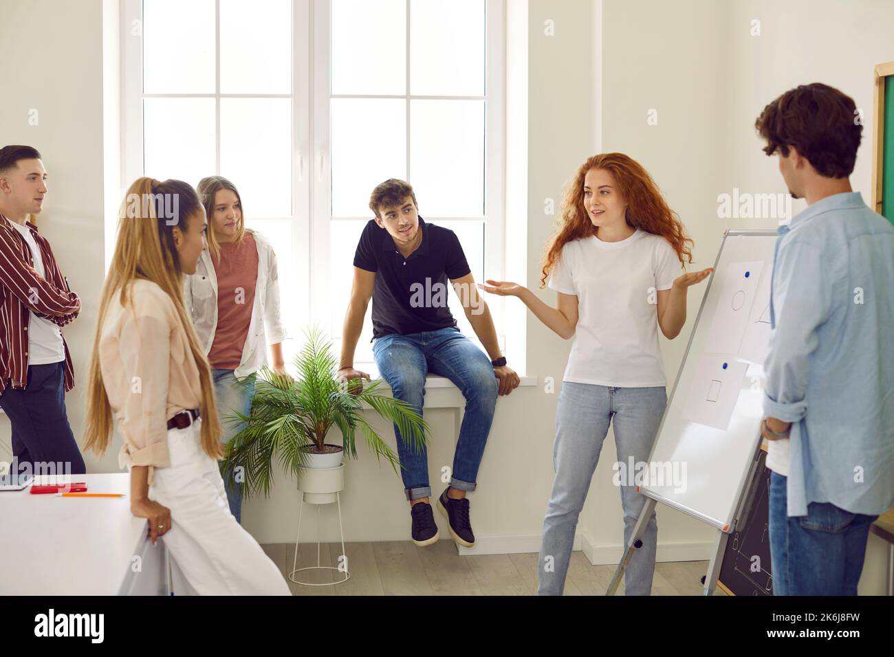 Students girl and guy making presentation using flipboard in modern ...