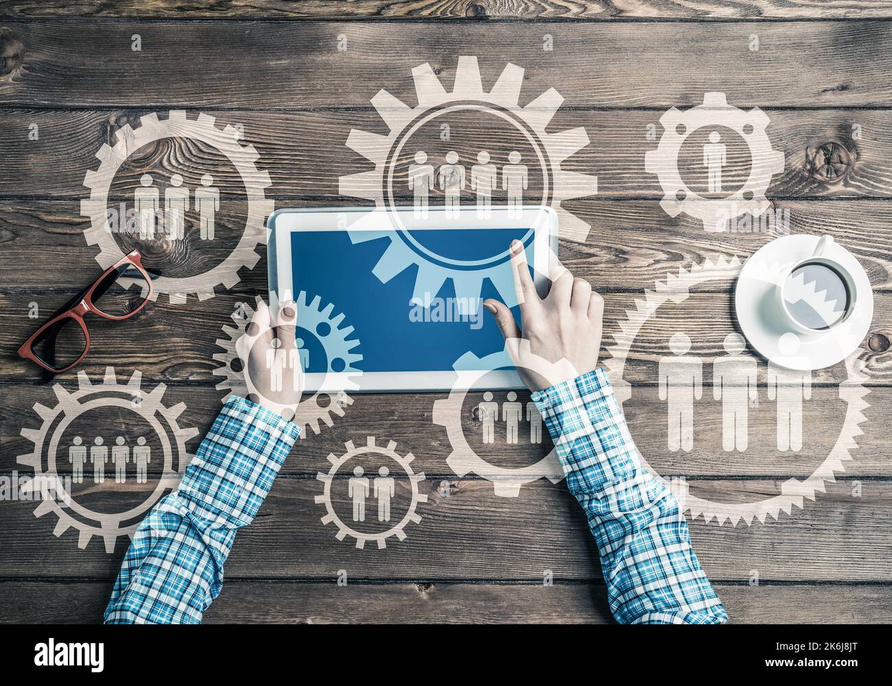 Concept of teamworking and connection with gears mechanism and tablet ...