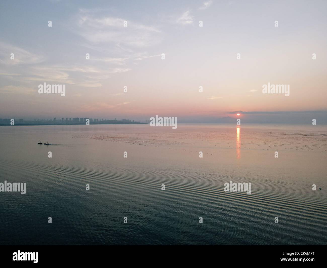 Aerial Drone Sunset View of the Pacific Ocean and the Skyline of Yantai ...
