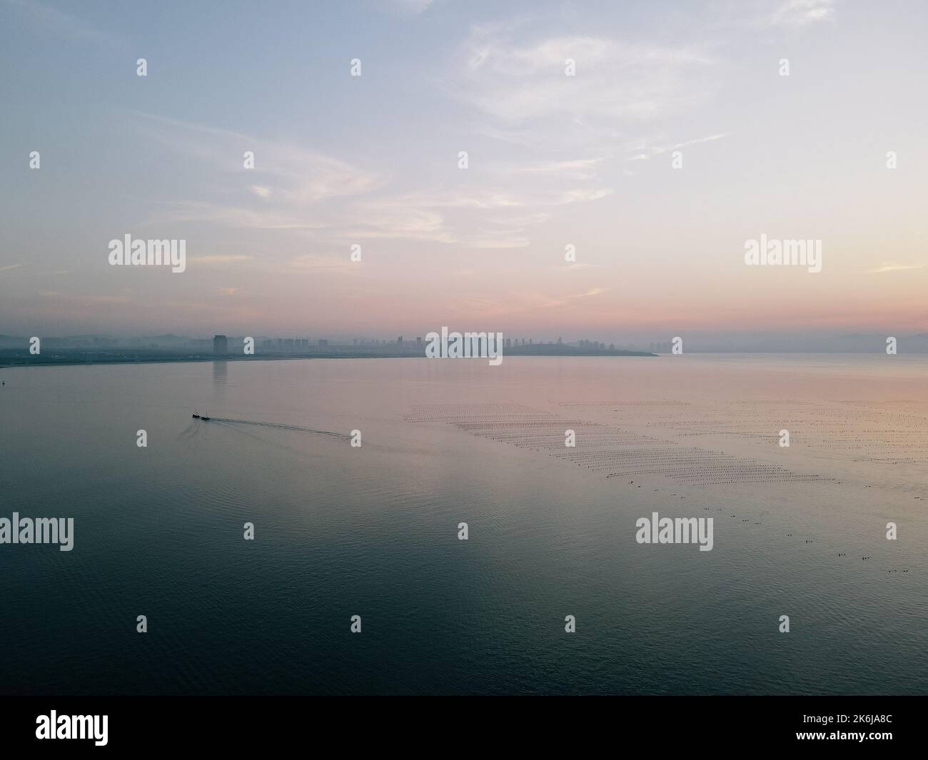 Aerial Drone Sunset View of the Pacific Ocean and the Skyline of Yantai ...