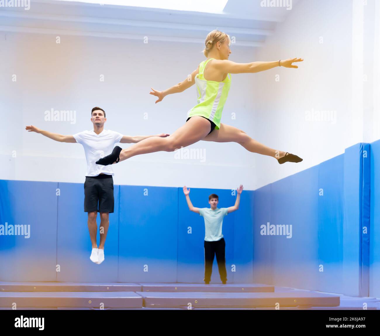 Woman training in trampoline center Stock Photo - Alamy
