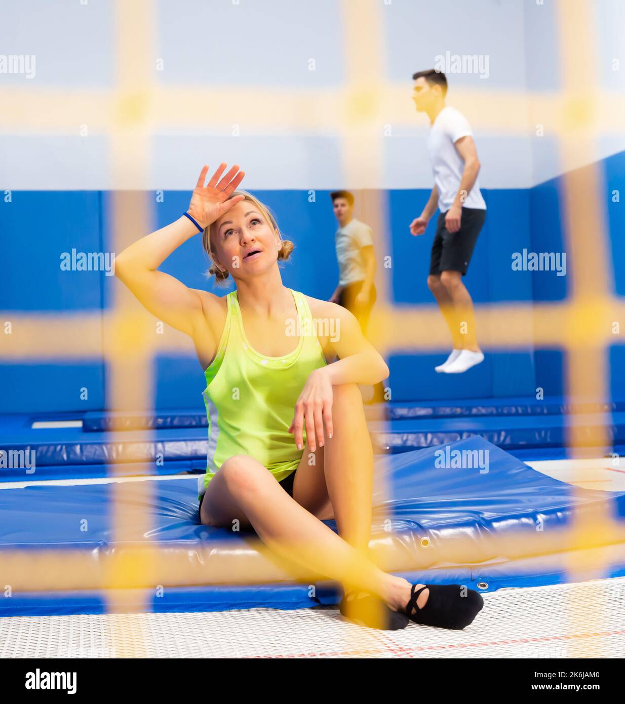 Woman having break during trampoline training Stock Photo - Alamy