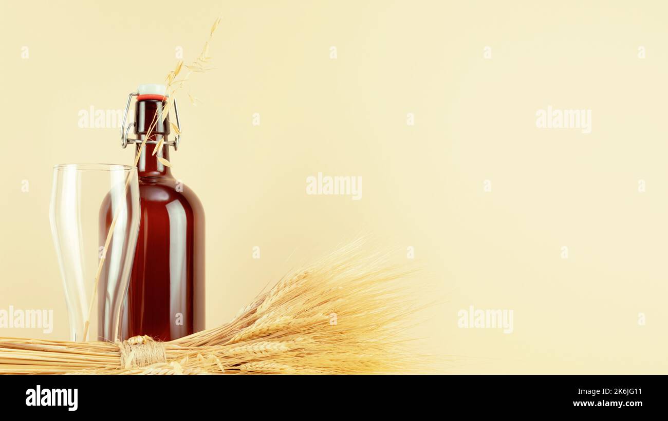 Bottle of beer and empty glass with bouquet of rye and wheat Stock ...