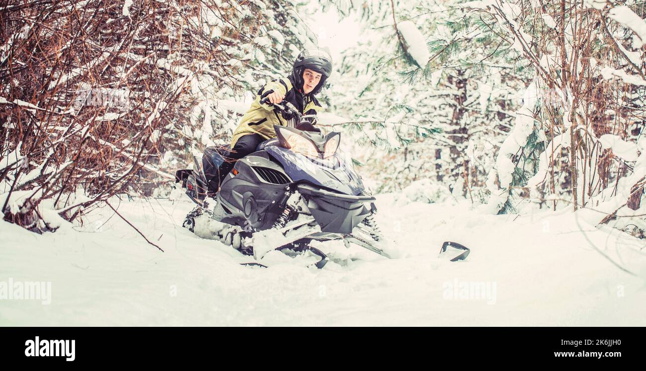 Man on snowmobile in winter mountain. Snowmobile driving. Man driving ...