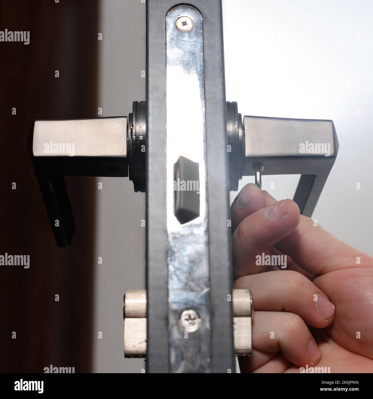 Hex key and installation of door lock and handle, close-up installation ...