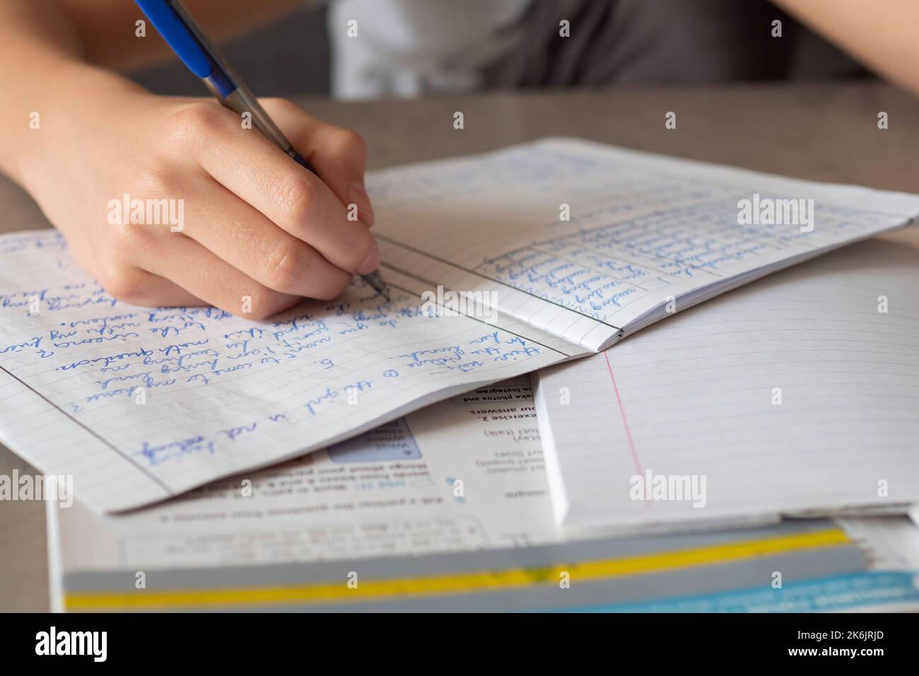 Child affected by dyslexia doing homework, reading book using colorful ...