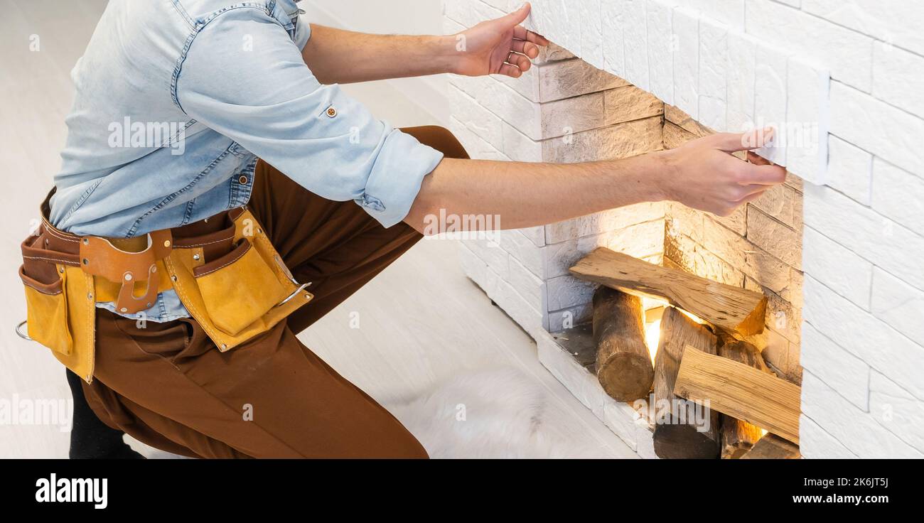 Professional technician installing electric fireplace in room Stock ...