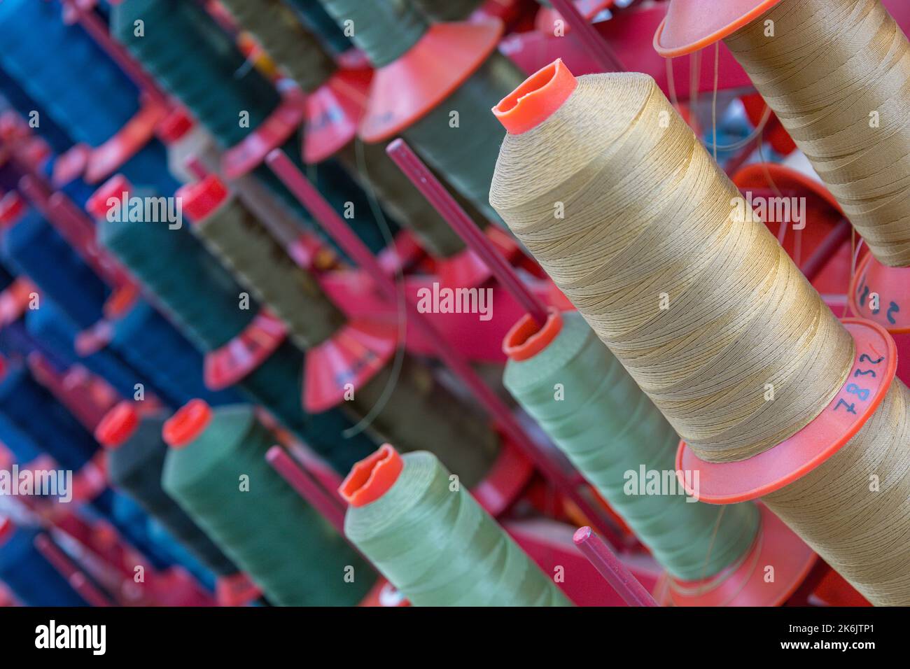 Panel of colored yarn rolls for textile industry Stock Photo - Alamy