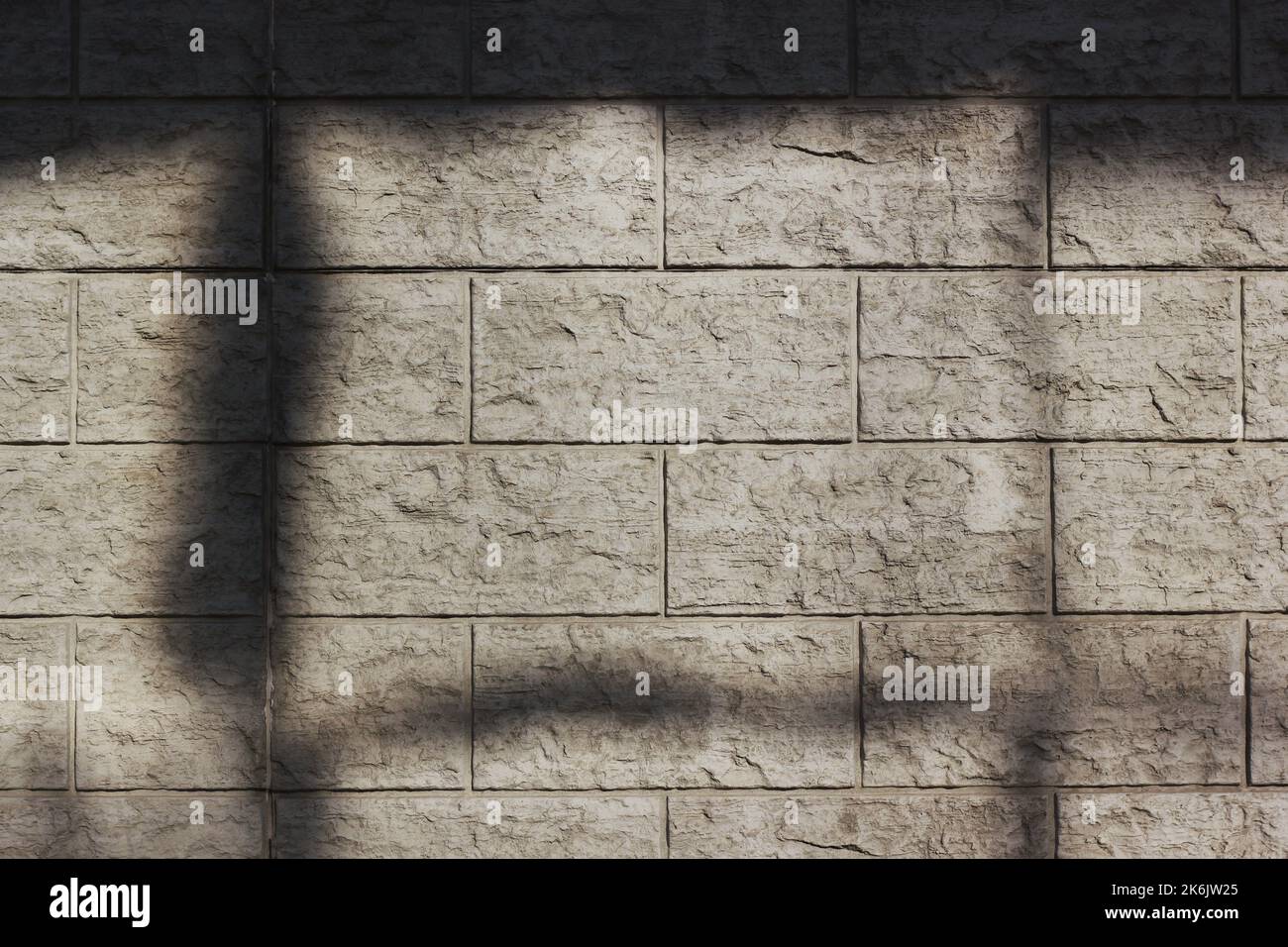 A typical common typical block natural stone wall with a shadow frame Stock Photo - Alamy