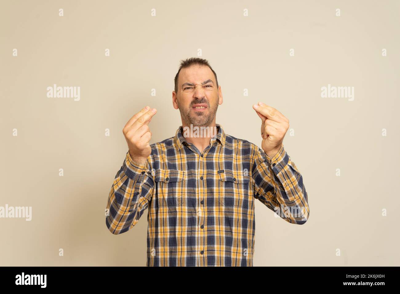 Portrait of handsome young man with beard showing italian gesture ...