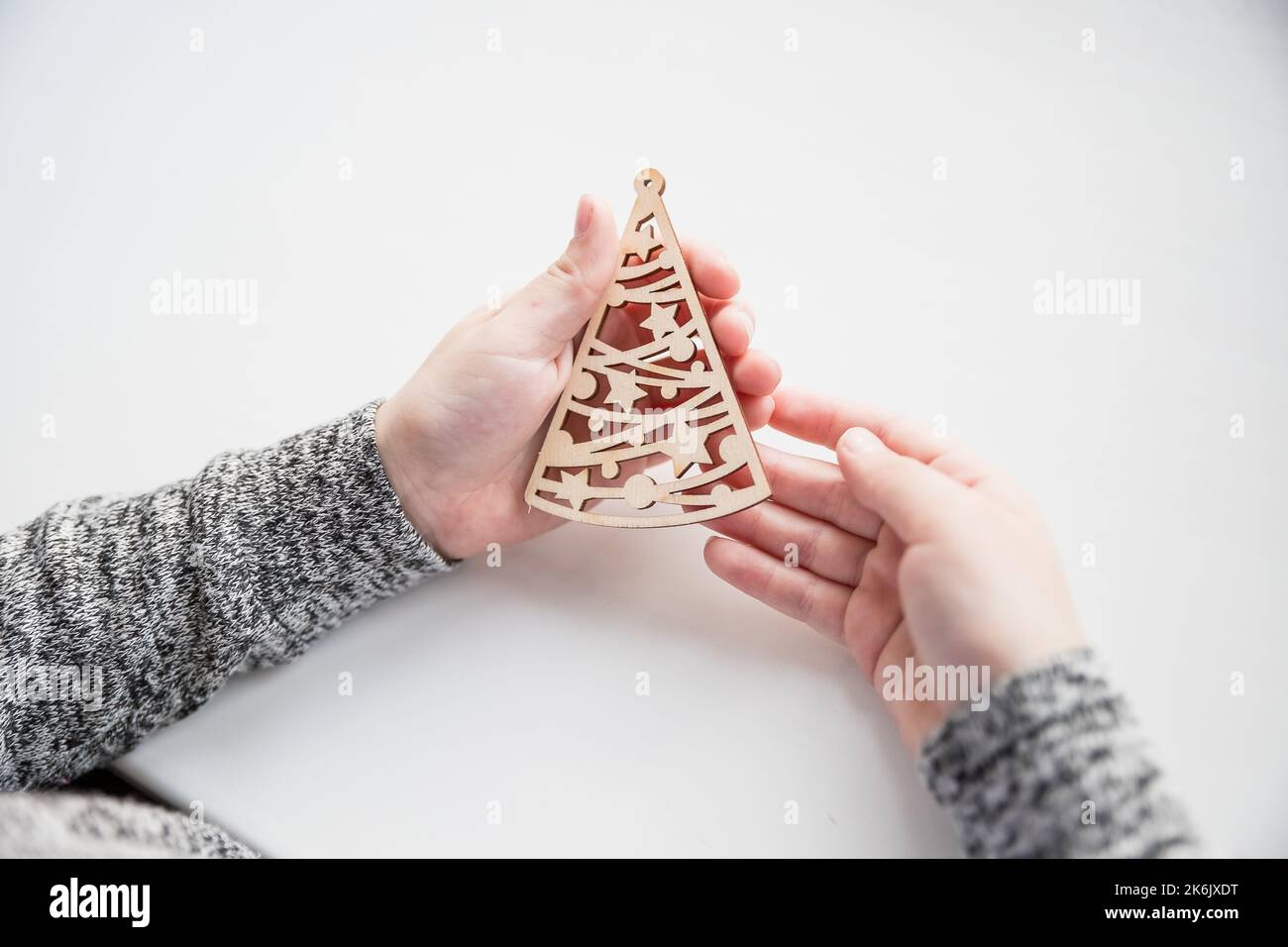 Girl makes wooden crafted Christmas ornaments at home, recyclable craft ...