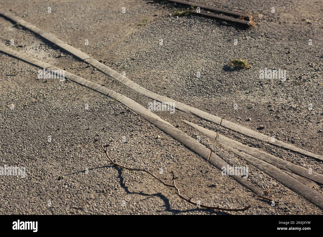 Minimalist view of simple typical railroad tracks crossing the street ...
