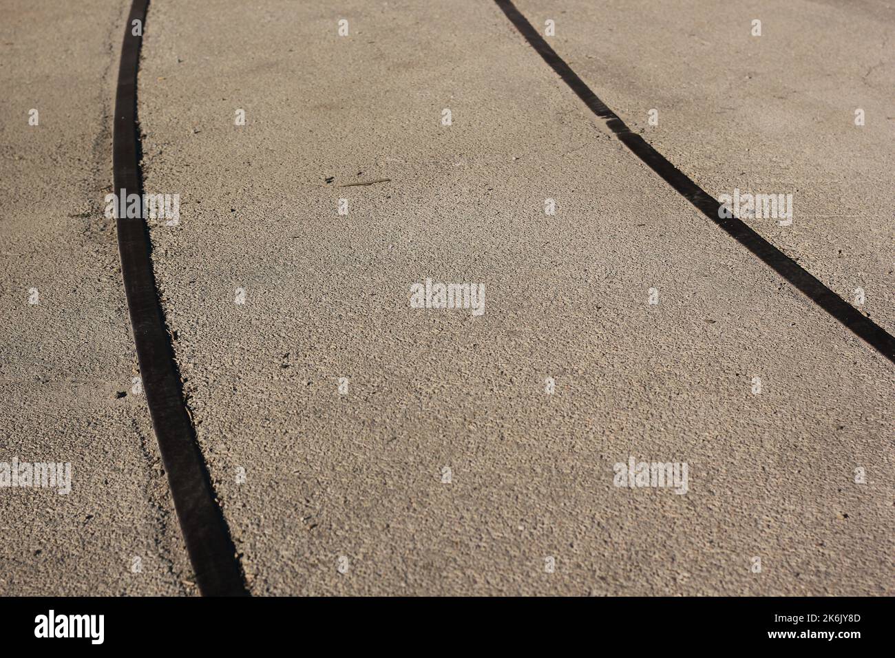 Minimalist view of simple typical railroad tracks crossing the street ...