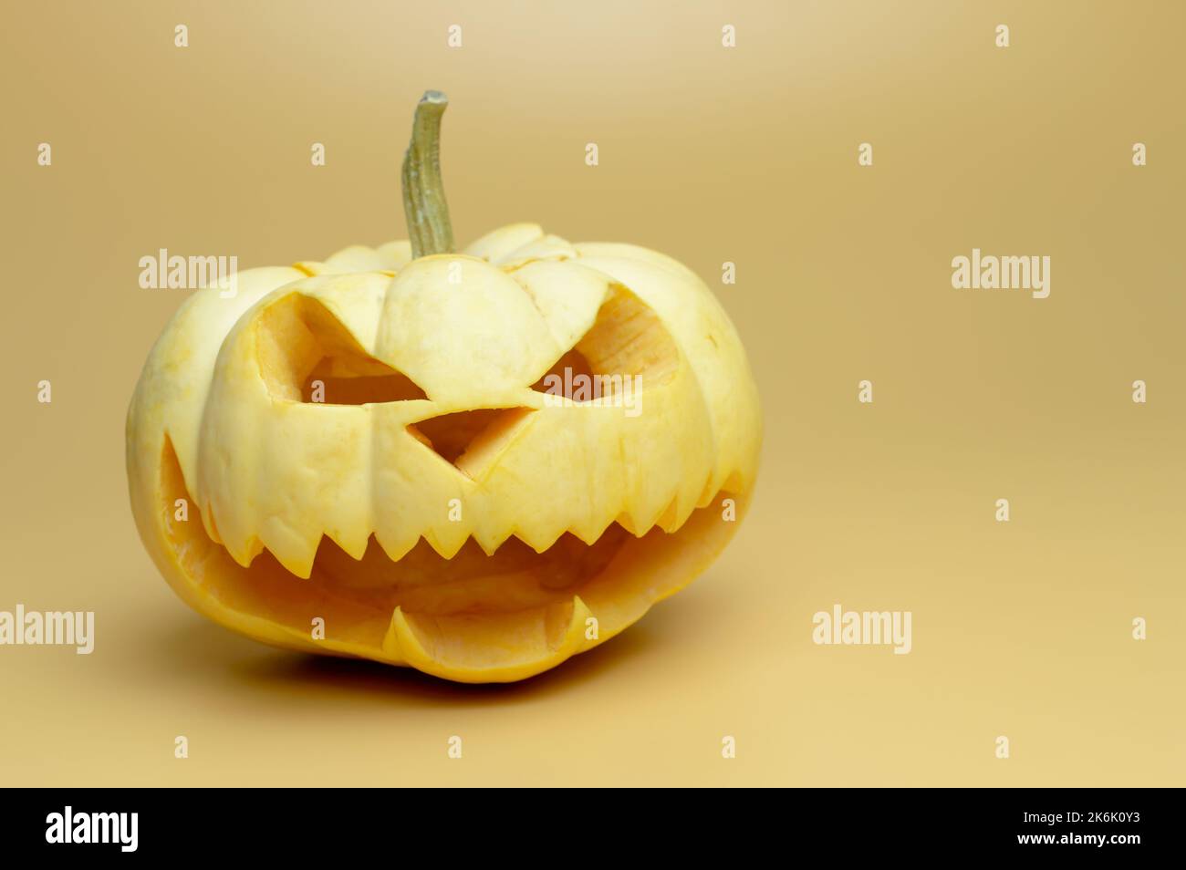 Yellow scary helloween pumpkin on a yellow background. Helloween ...