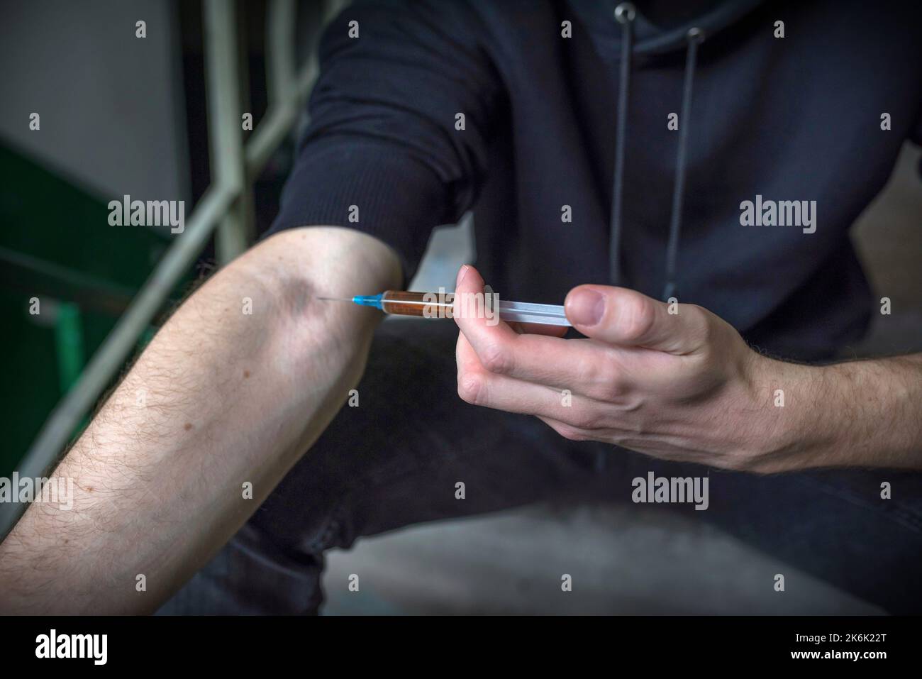 Addict man with syringe in action. Addiction concept Stock Photo - Alamy