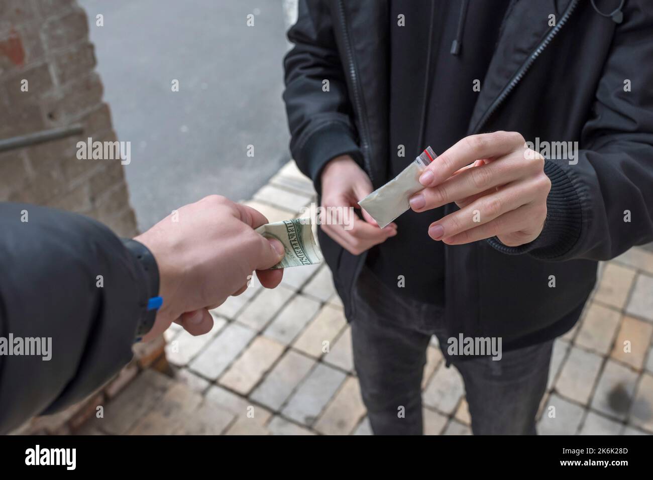 An addict with money buys a dose from a dealer on the street. Addiction ...