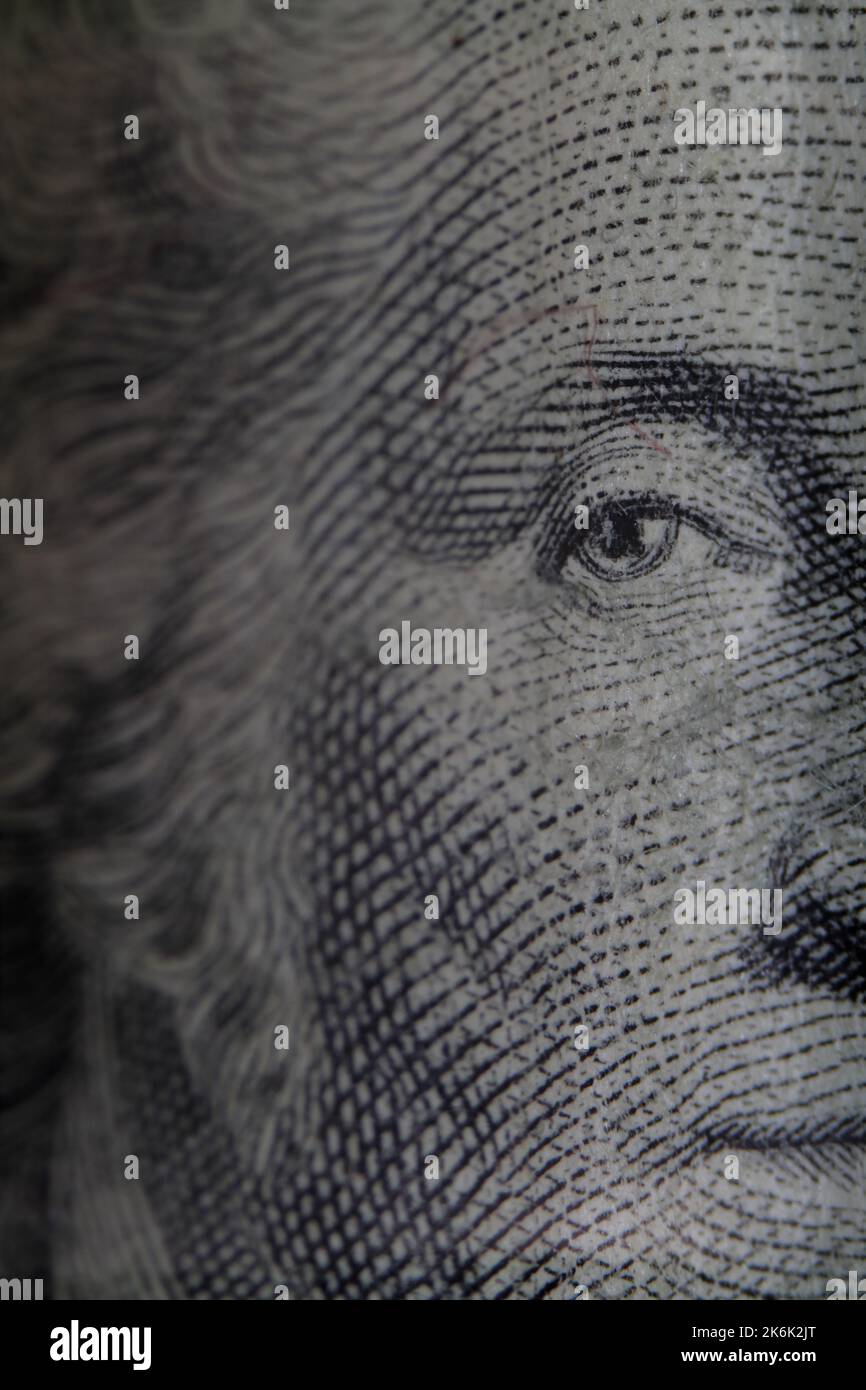 Macro view of George Washington eye on worn out dirty US one dollar ...