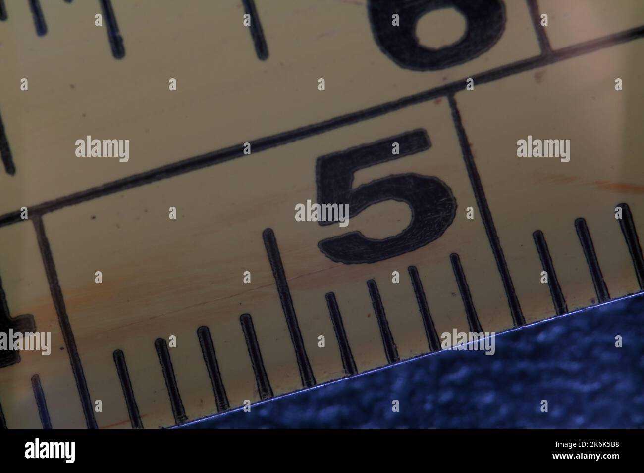 Close-up of the yellow measuring tape indicating the measure 5. Number ...