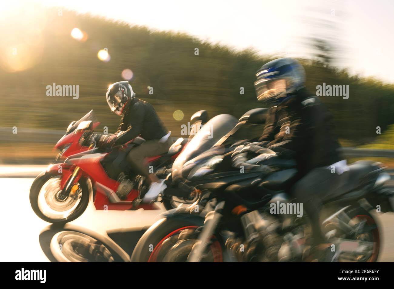 Two supersport race motorcycle riders going fast side by side on the ...