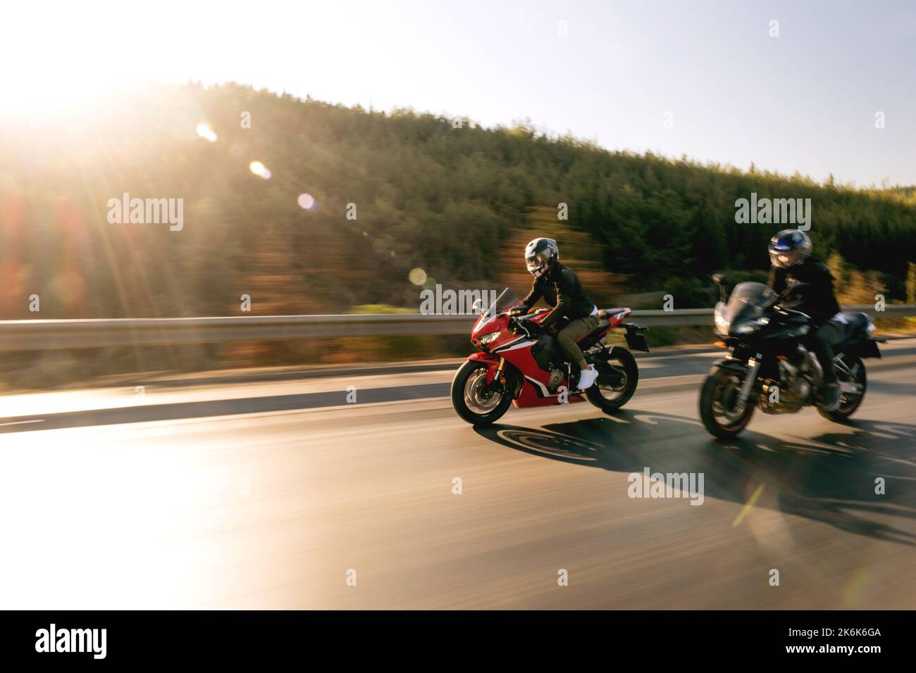 Two supersport race motorcycle riders going fast side by side on the ...