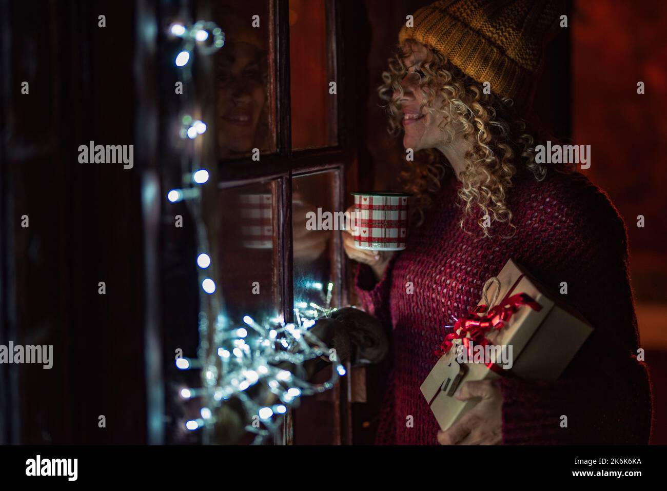 One woman alone at home drinking tea in christmas holiday season ...