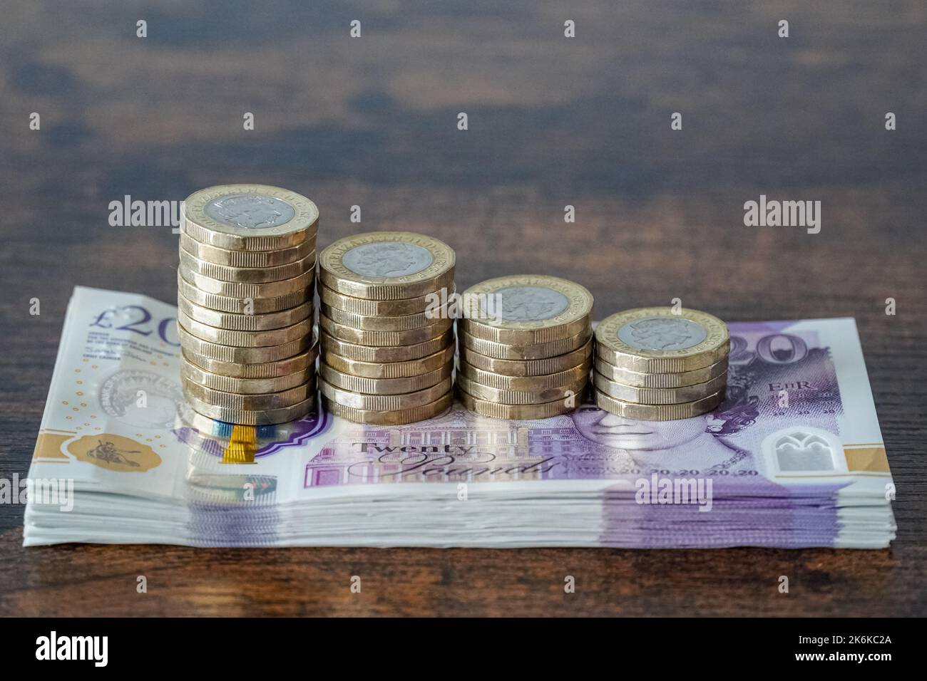 British twenty pound notes and one pound coins Stock Photo - Alamy