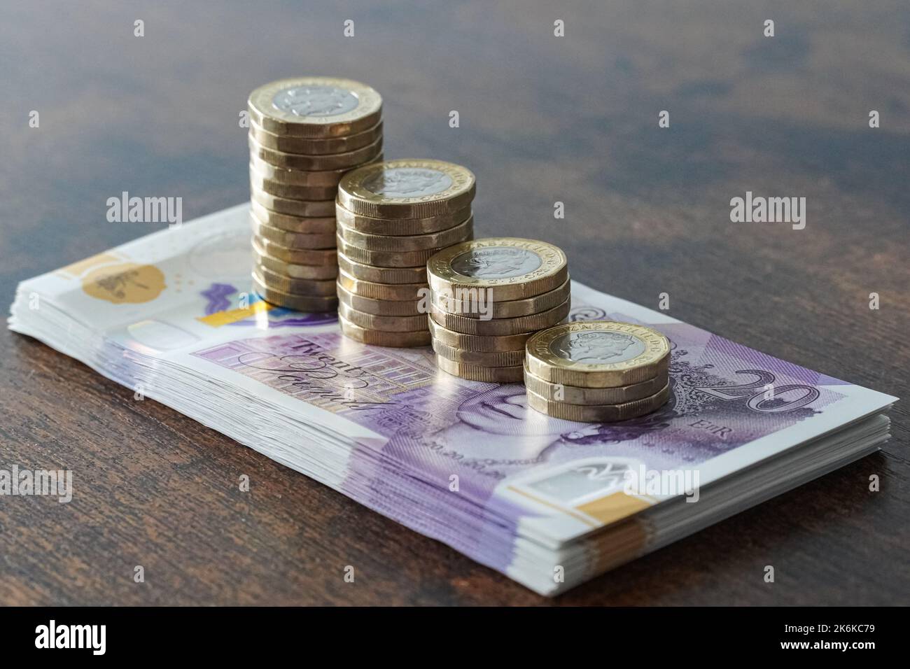 British twenty pound notes and one pound coins Stock Photo - Alamy