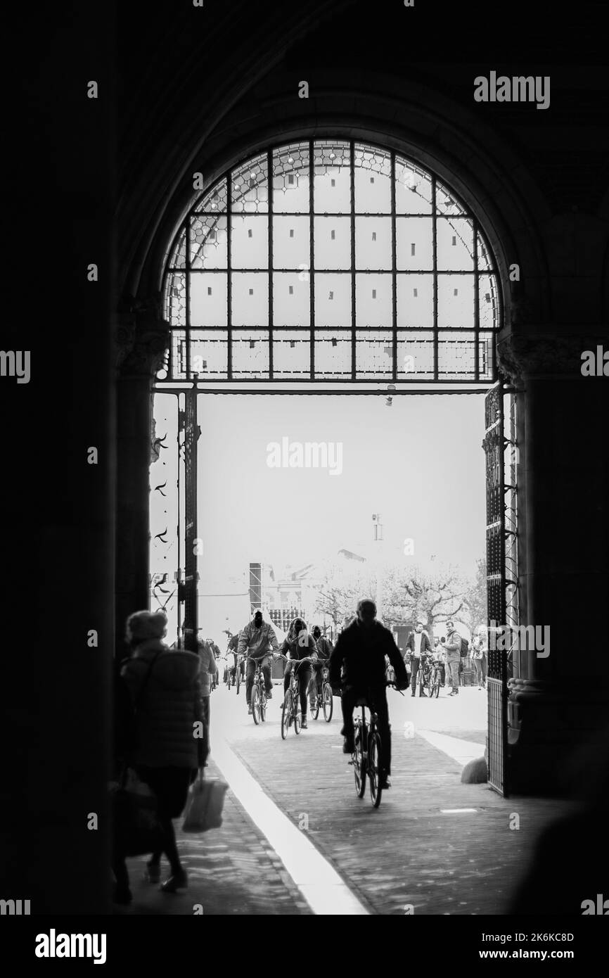 cyclist cross the gate of the street market in Amsterdam Stock Photo ...