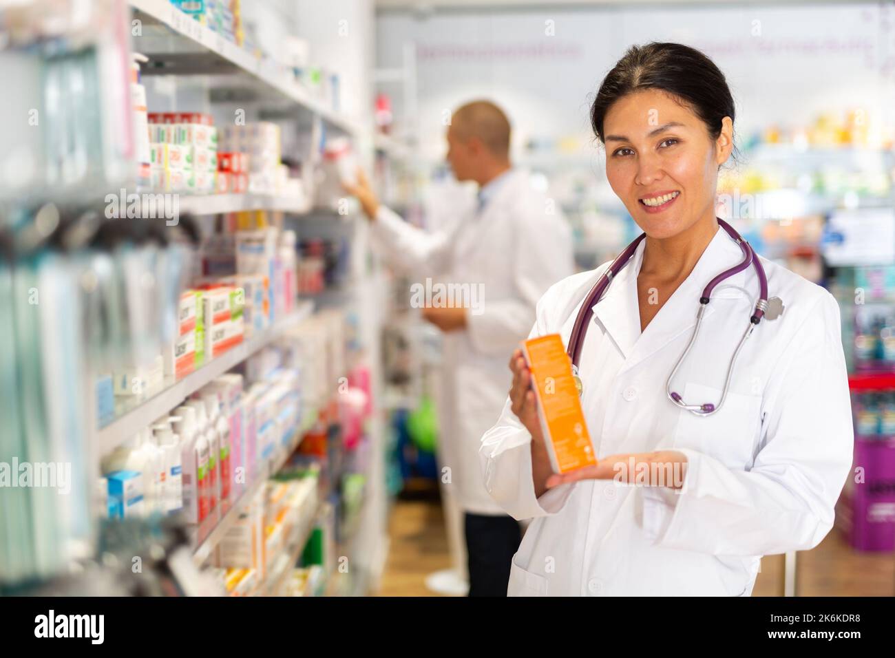 Female pharmacist offers medicine while standing in the trading floor ...