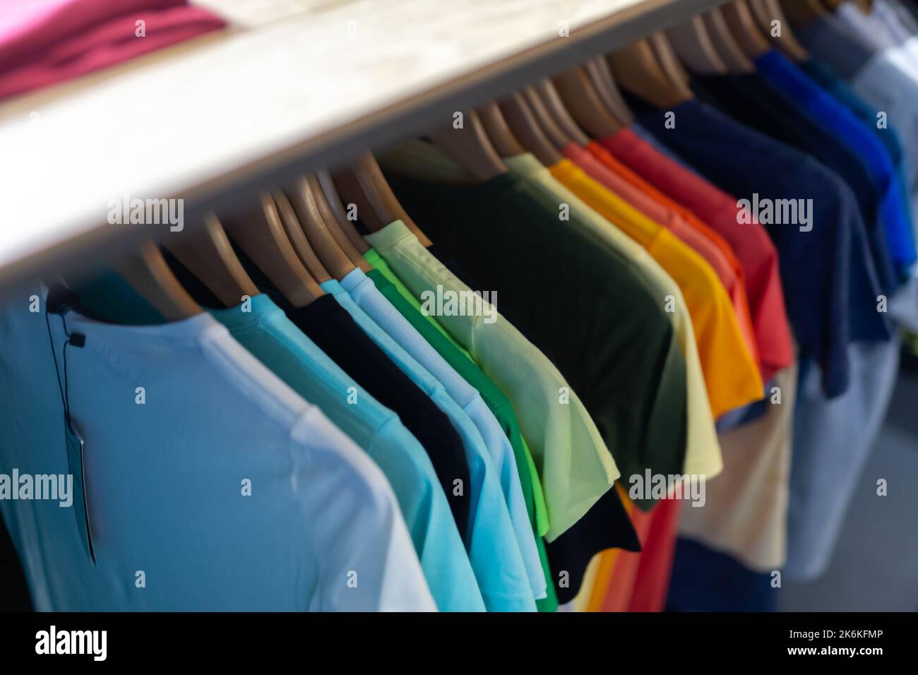 Assortment of summer clothing in modern store Stock Photo - Alamy