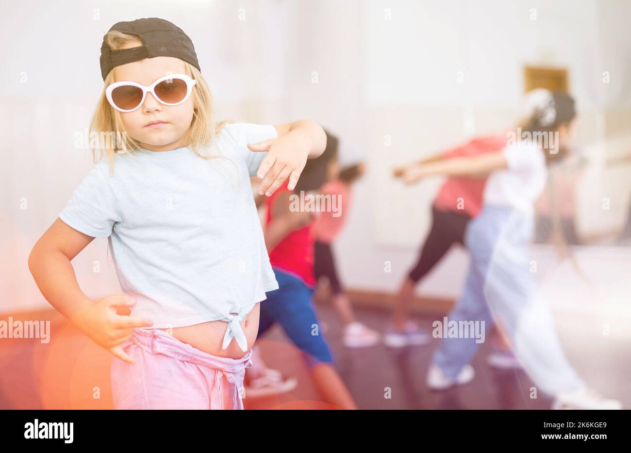 Preteen girl training hip-hop movements during group dance lesson Stock ...