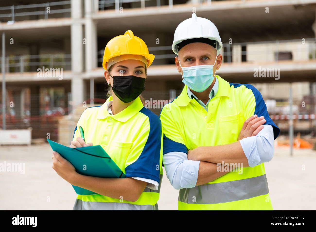 Engineers in face masks standing in construction plant Stock Photo - Alamy