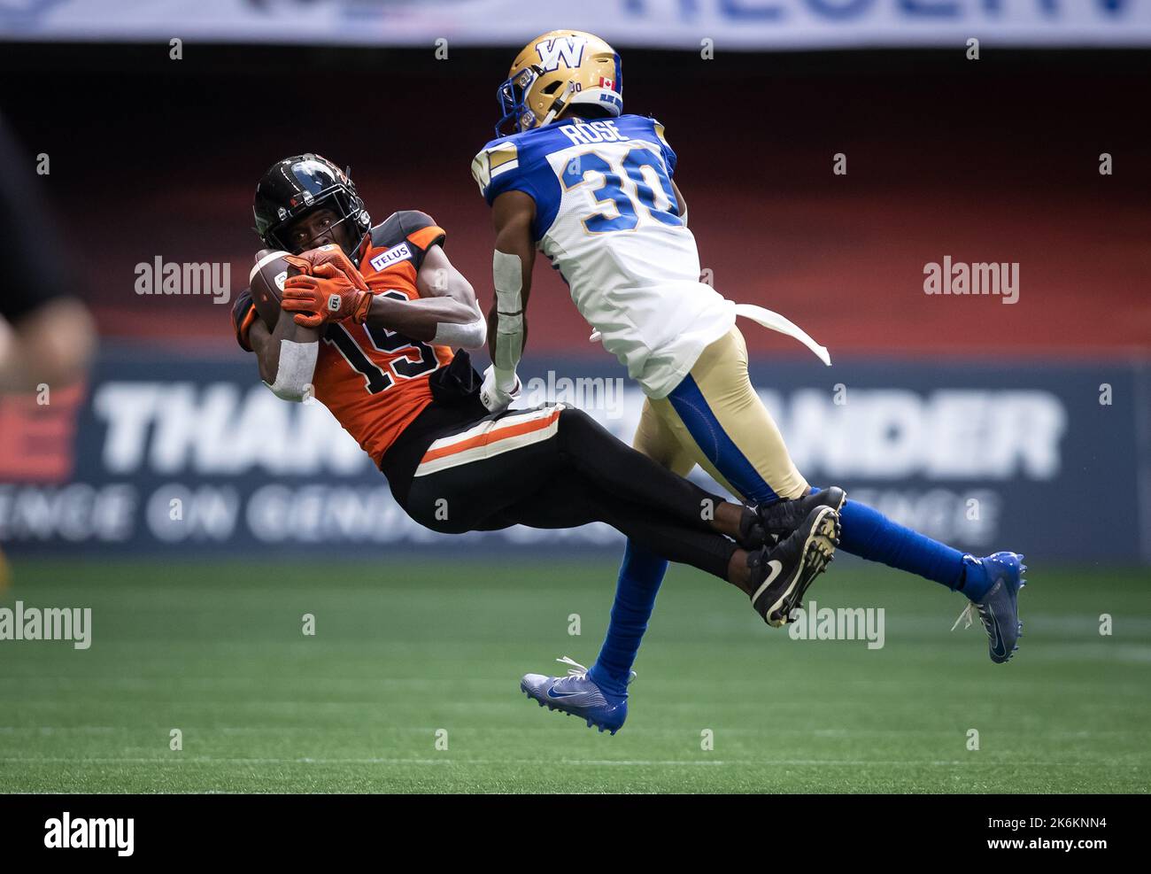 B.C. Lions' Dominique Rhymes, left, makes a reception as Winnipeg Blue ...